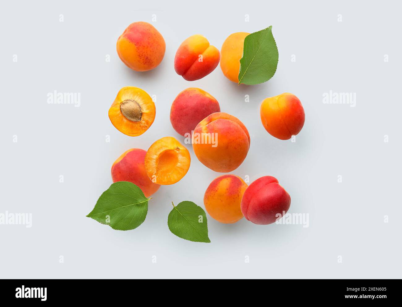 Flying apricots with leaves on grey background Stock Photo - Alamy