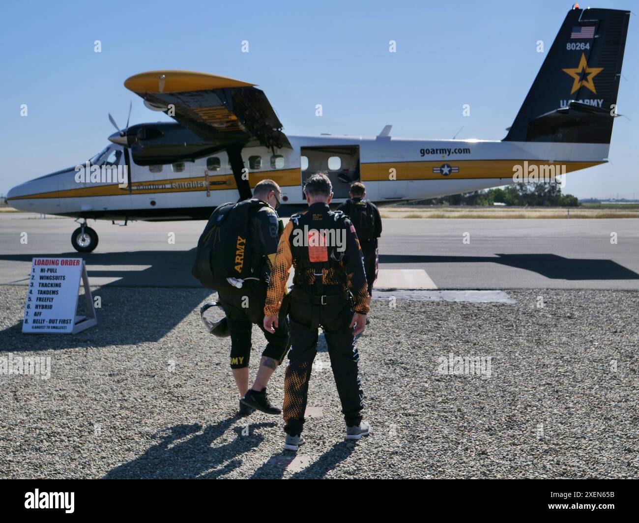 Jumpers and members of the Golden Knights Tandem Team prepare to board ...