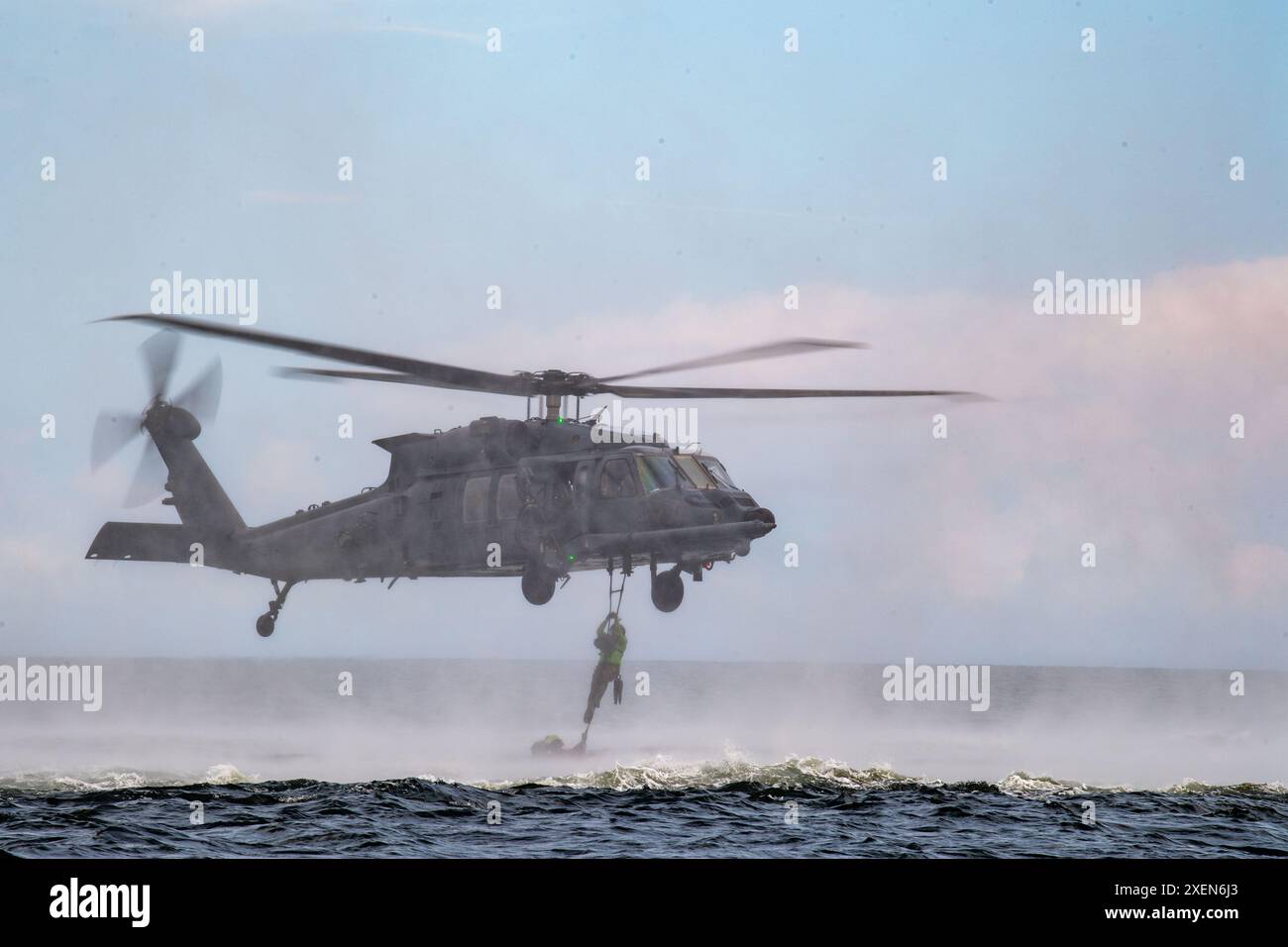 U.S. Air Force HH-60W Jolly Green II pilots hover at low altitude in ...