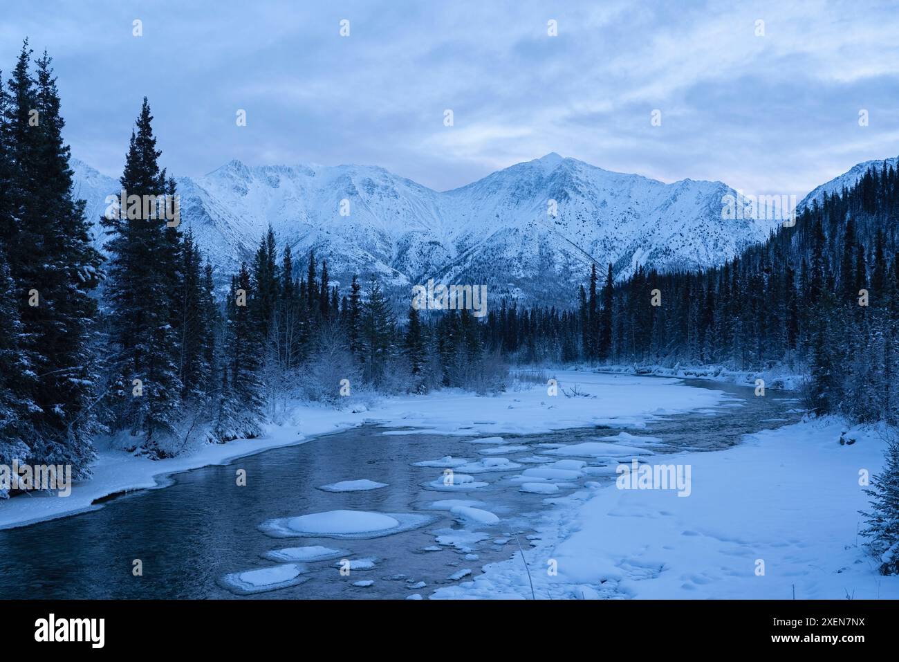 Winter sets in the Yukon as the mountains and trees surrounding the ...
