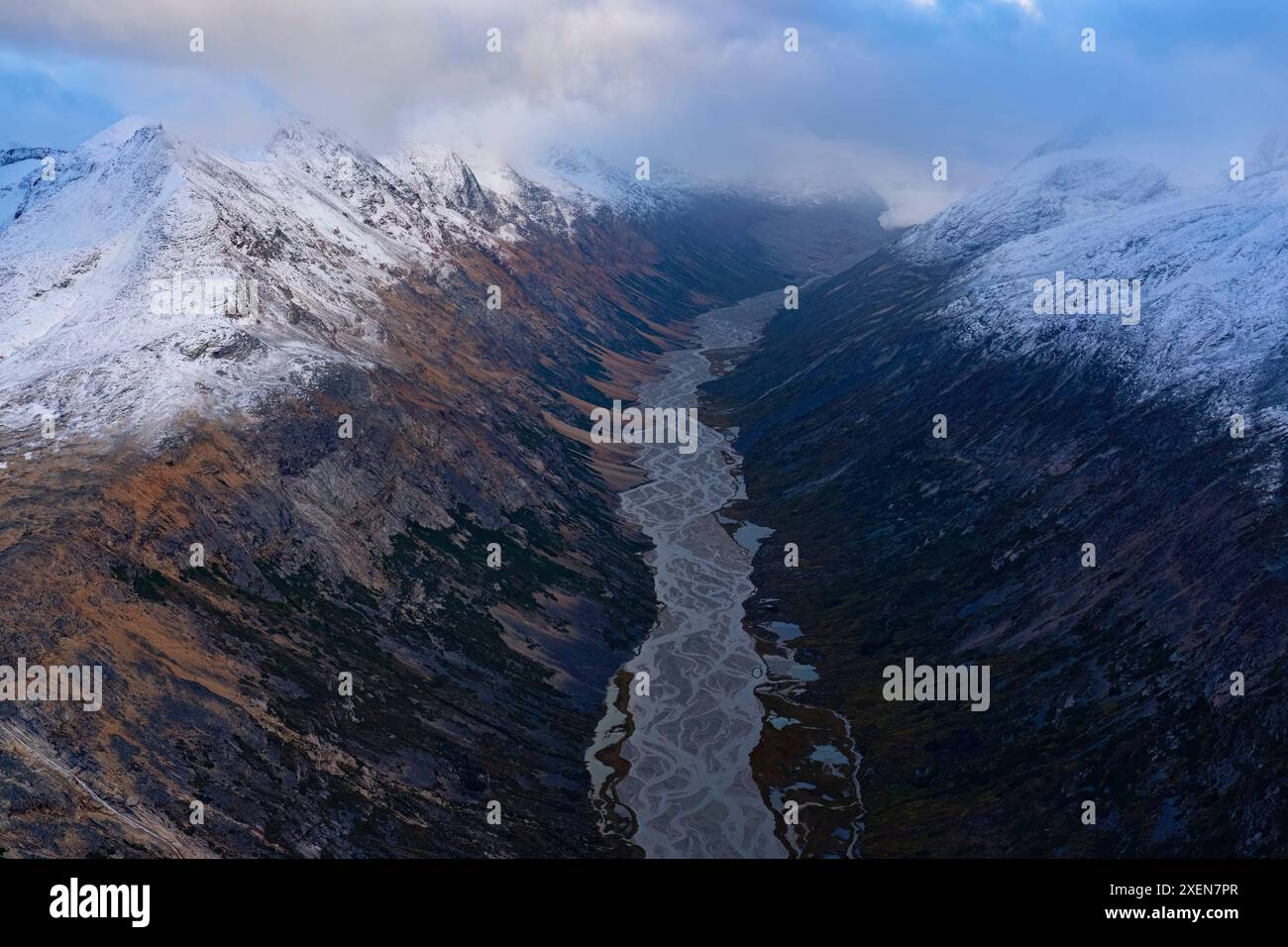 Amazing aerial view of a riverbed valley dividing two majestic mountain ...