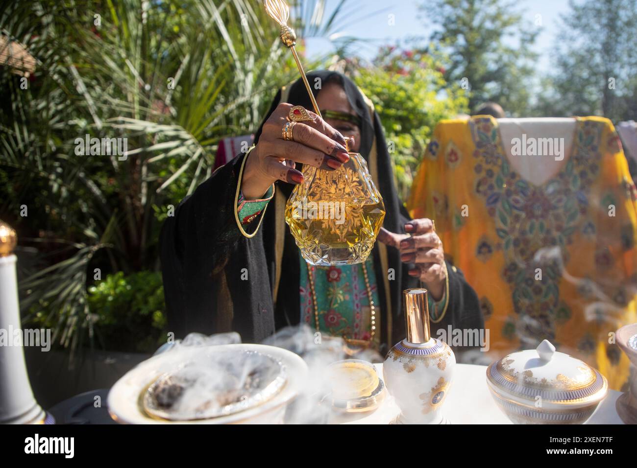 An Arab woman puts on A scent of an expensive perfume Stock Photo - Alamy