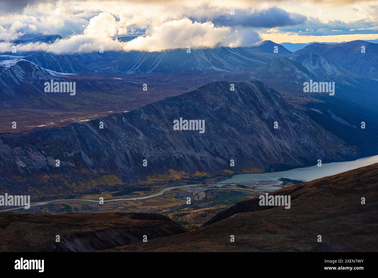 Aerial photos of a river flowing bu a cliff face of the mountains ...