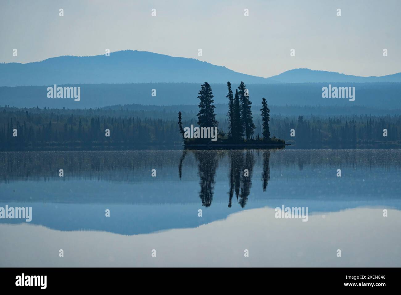 Reflections on a Yukon Lake in summer. This is Tarfu Lake in the ...
