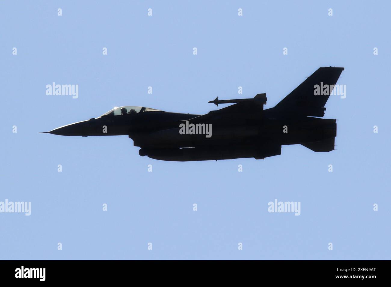 A military airplane flying in blue sky Stock Photo - Alamy