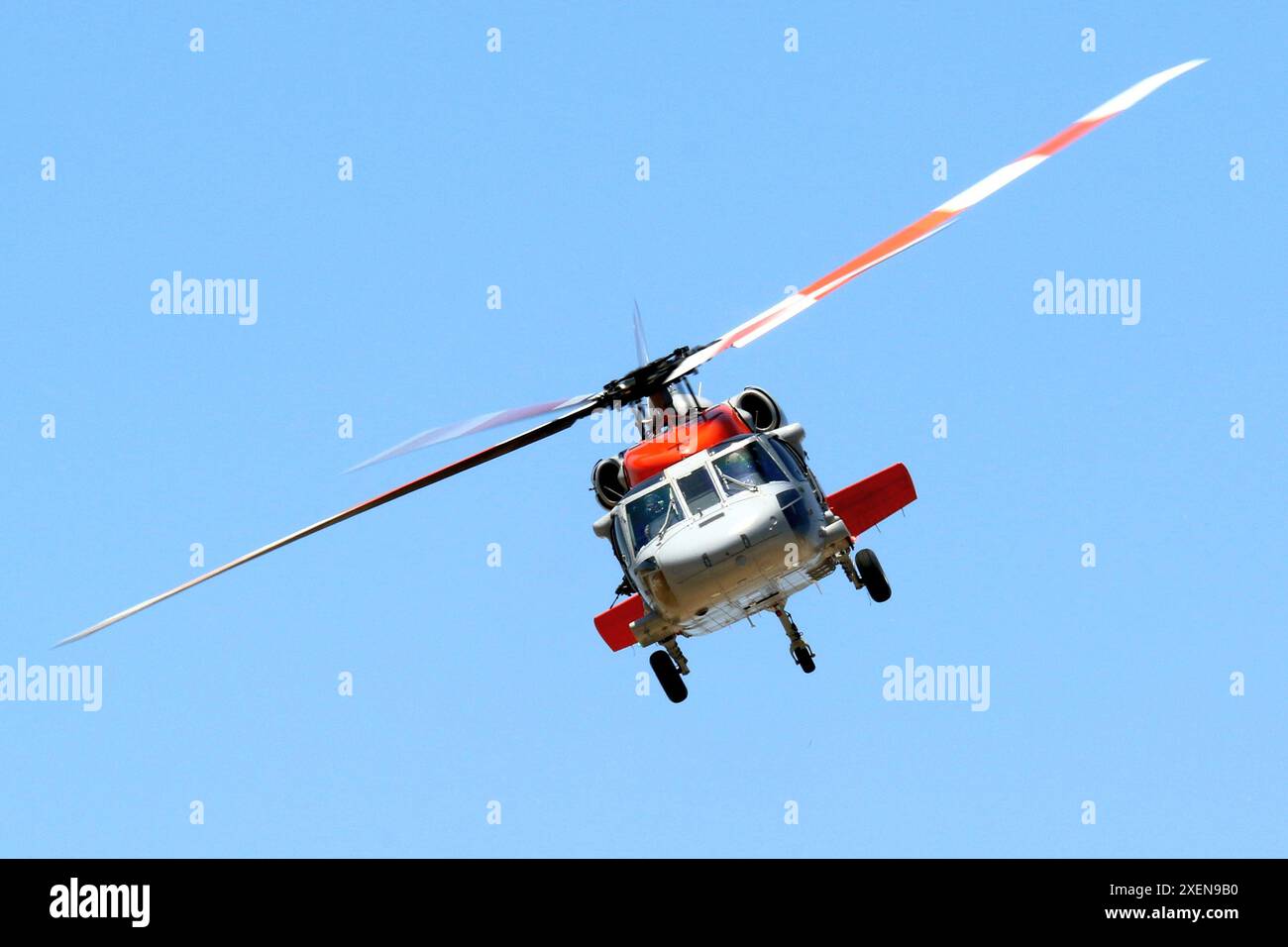 Red helicopter flying in blue hi-res stock photography and images - Alamy