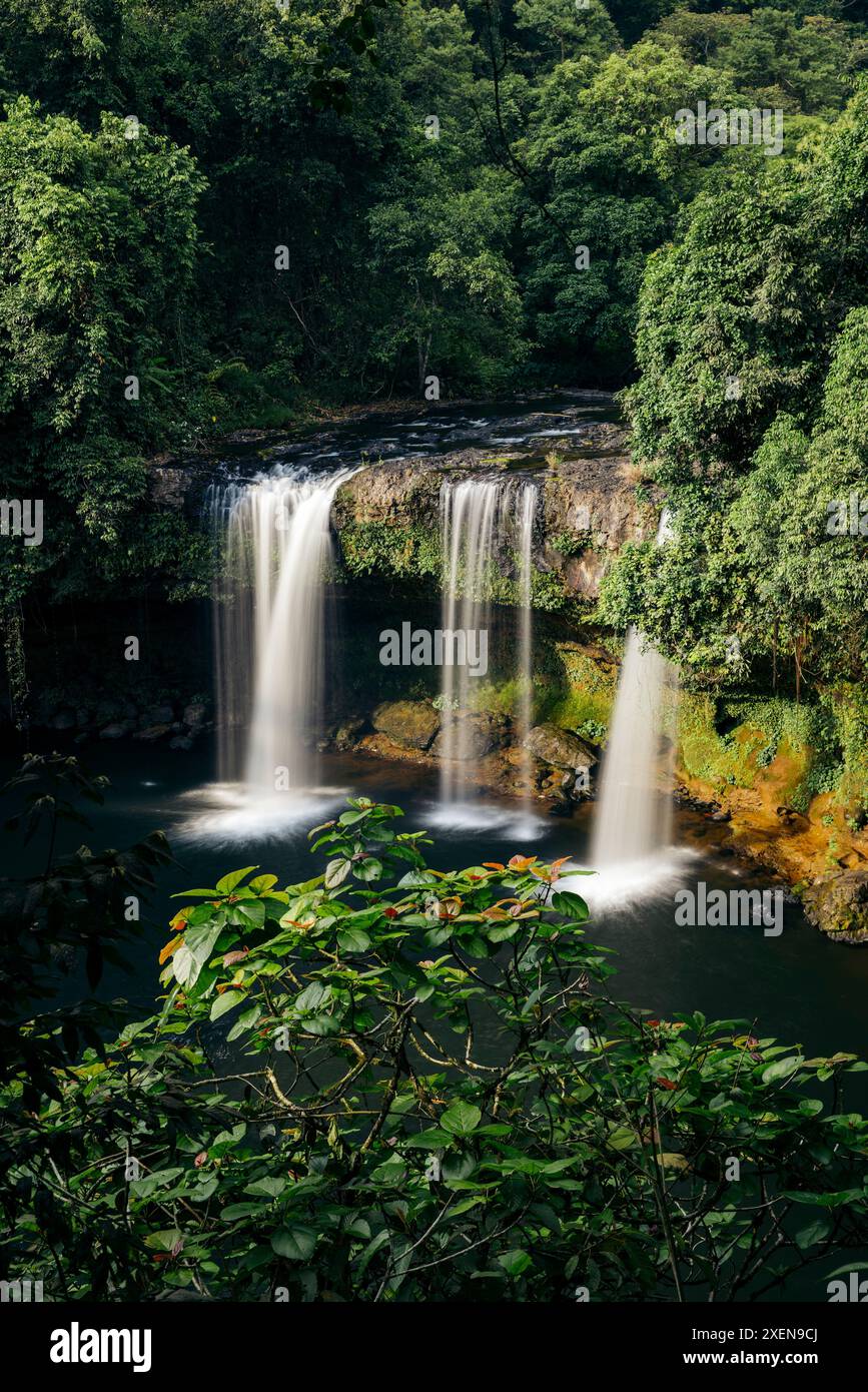 Long exposure of three waterfalls and lush foliage at Tad Champee ...