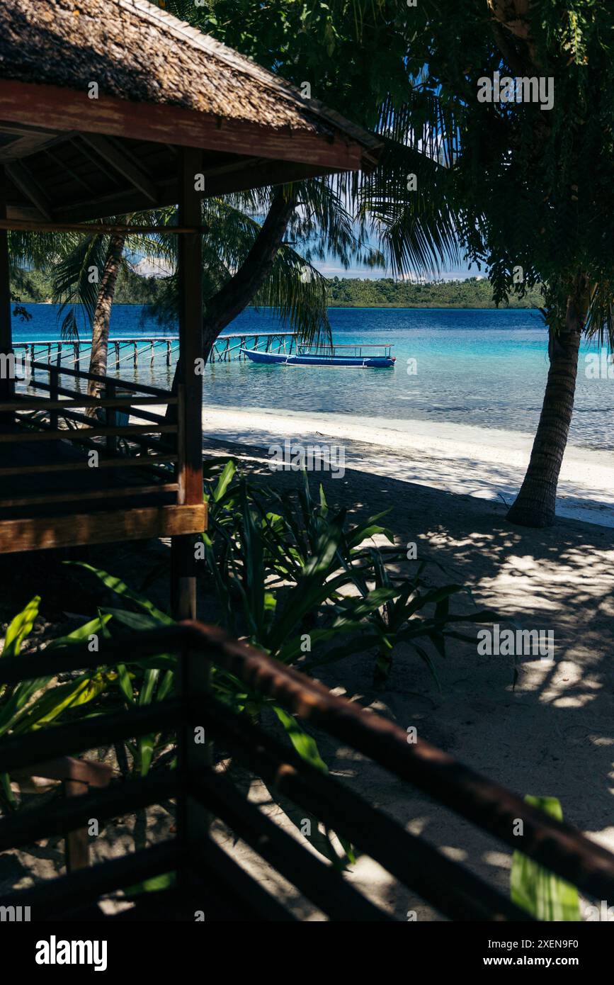 Structure and dock along a white sand beach on Bolilanga Island in the ...