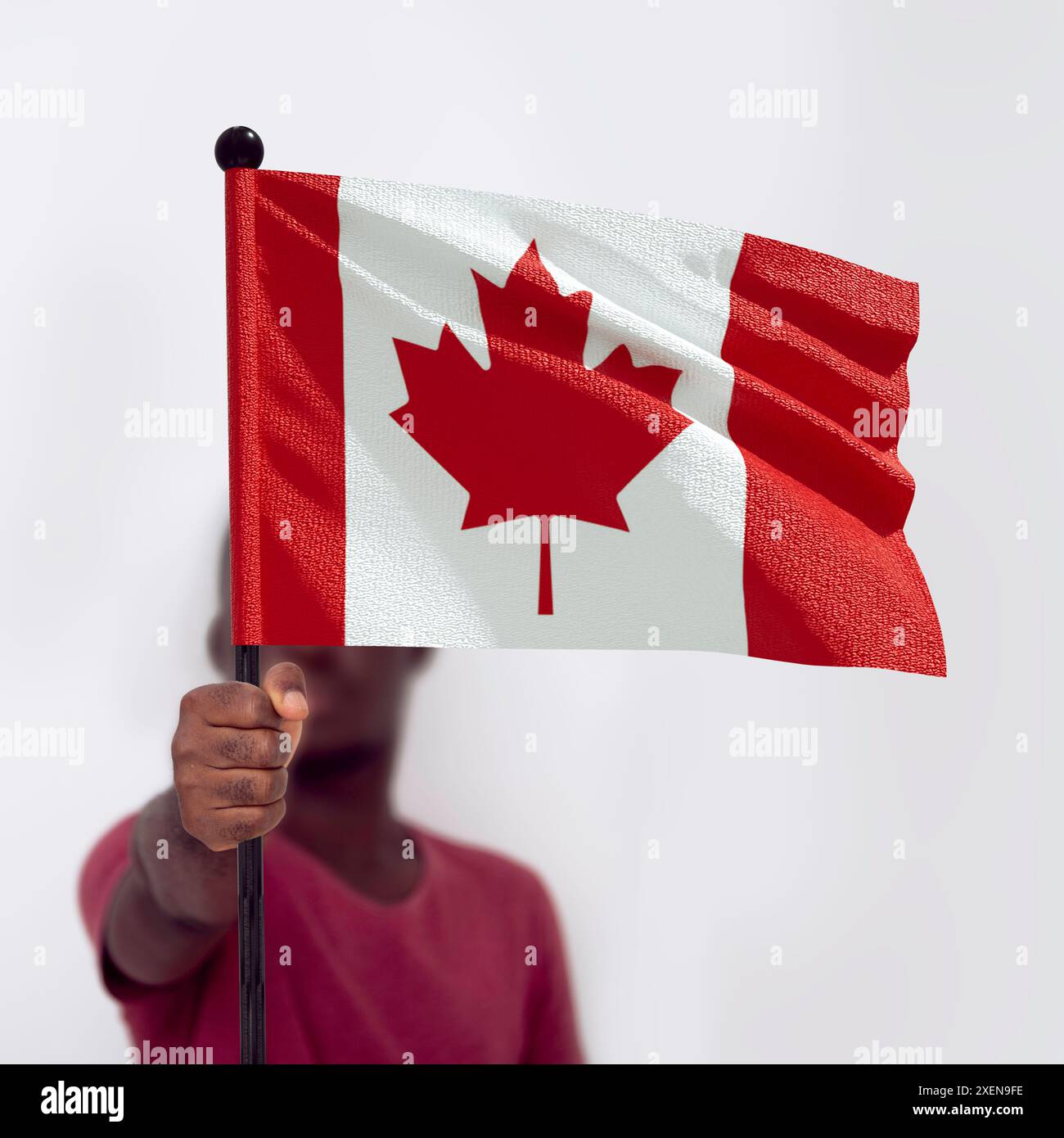 Black african male holding Canadian national flag against white ...