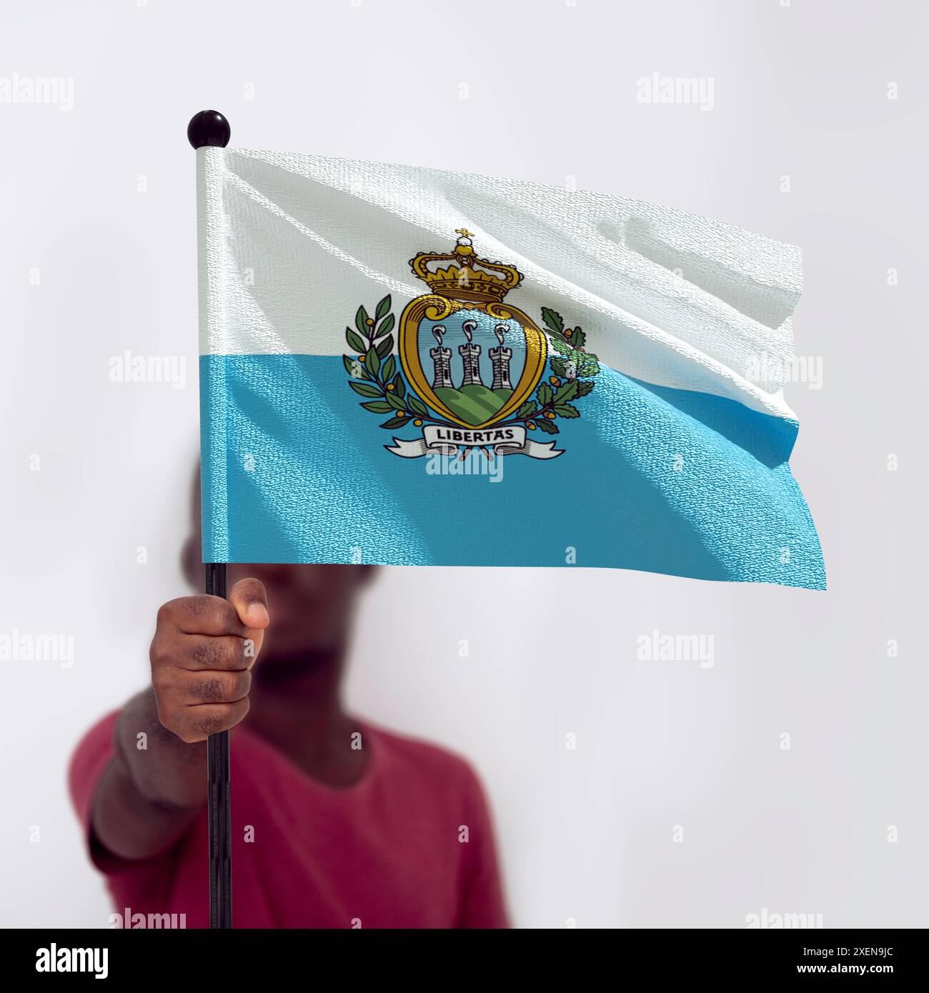 Black african male holding san marino national flag against white ...
