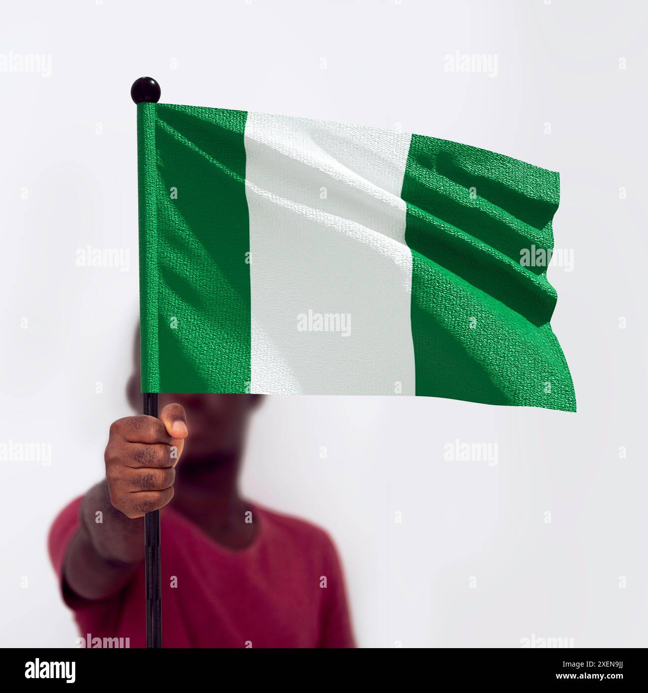 Black african male holding Nigerian national flag against white ...
