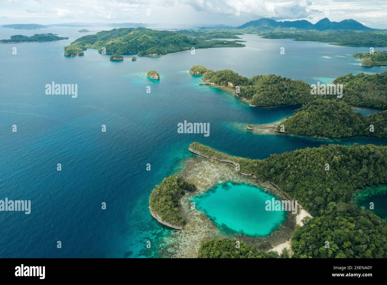 Aerial view of an aquamarine lagoon in Kepulauan Togean National Park ...
