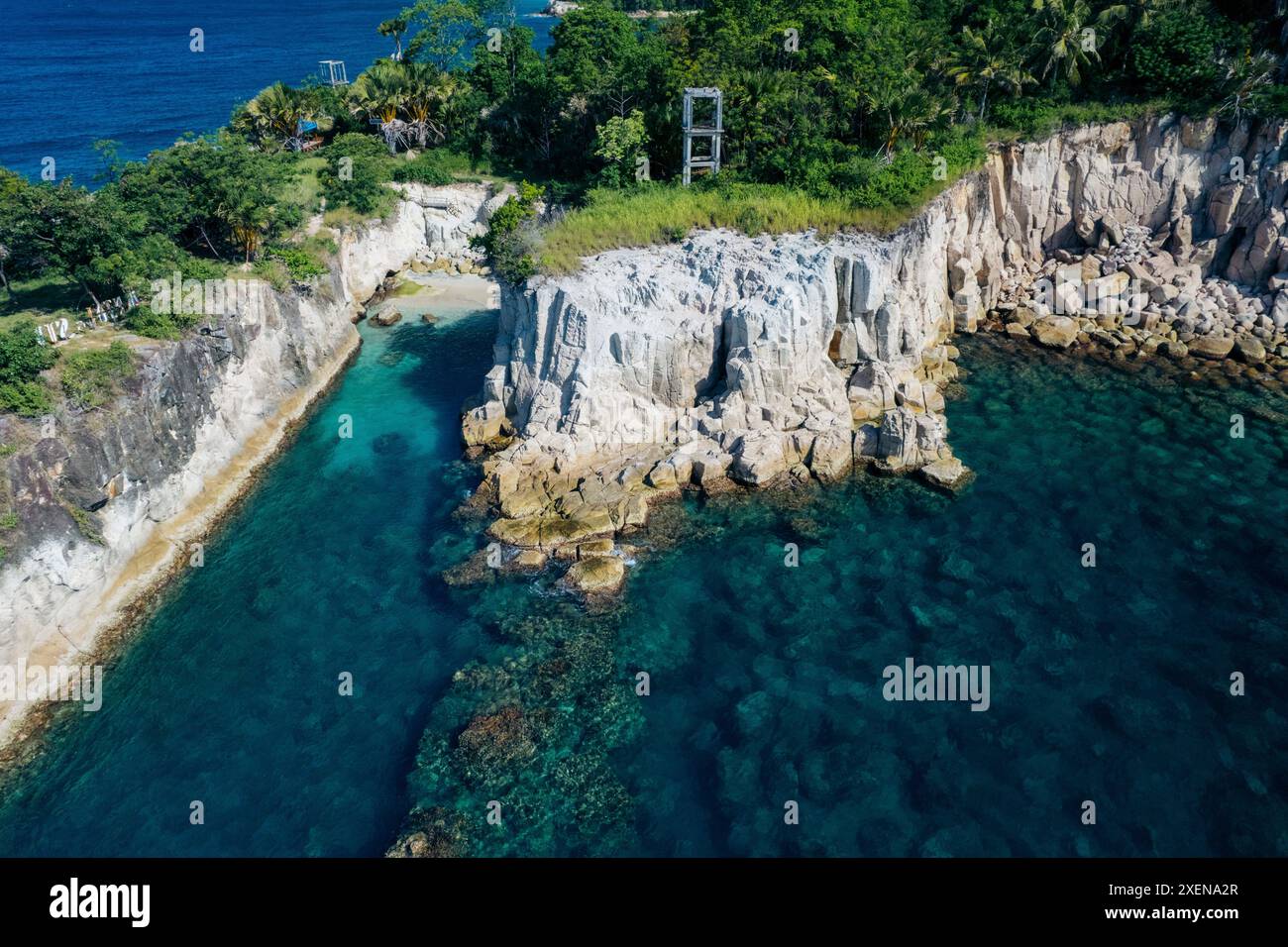 Patokan Beach (Jiko) cliffs and clear turquoise water in North Sulawesi ...