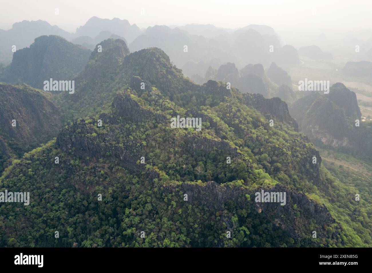 Limestone karst formations in sunset light in the Thakhek area of Laos ...