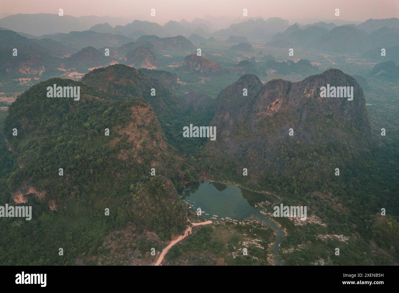 Limestone karst formations in sunset light in the Thakhek area of Laos ...