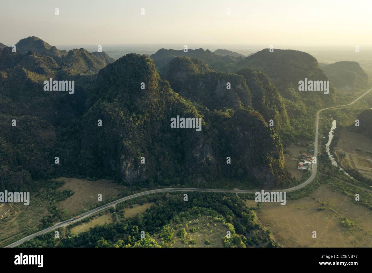 Road winding by limestone karst formations in the Thakhek area of Laos ...