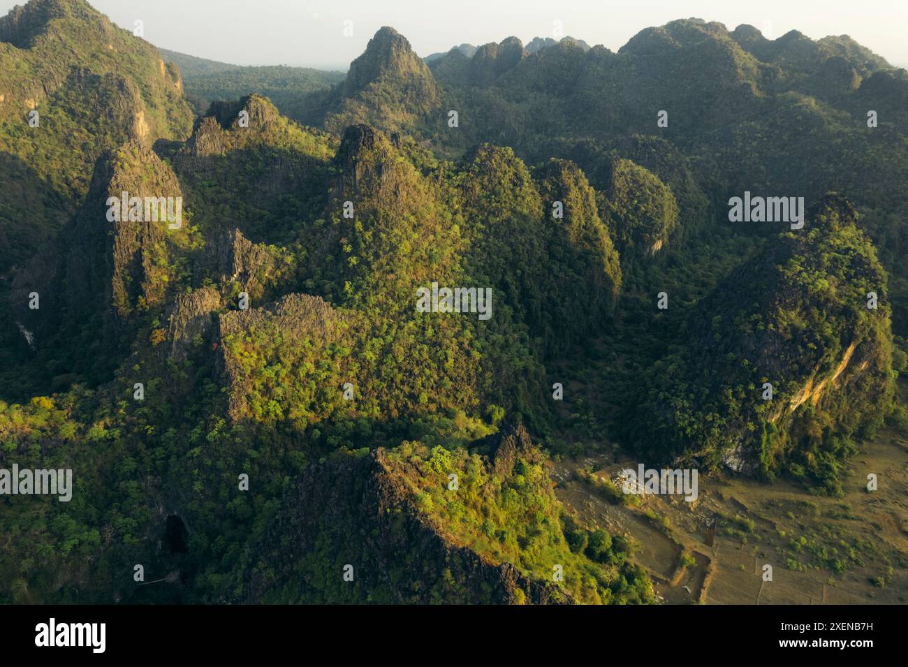Karst formations covered in lush vegetation in the Vang Vieng area of ...