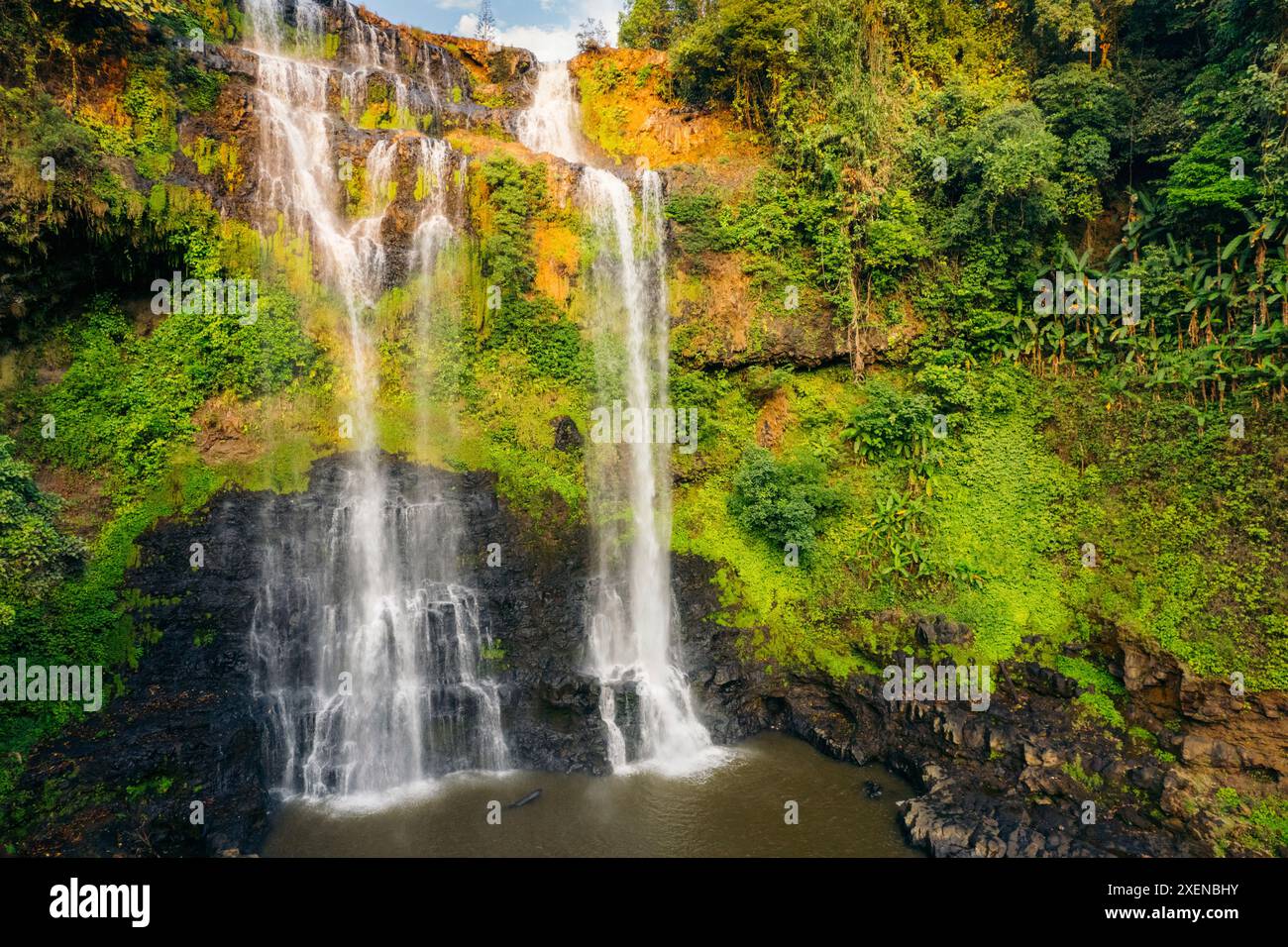 Waterfalls at Tad Gneuang Waterfall, dropping from a high cliff with ...