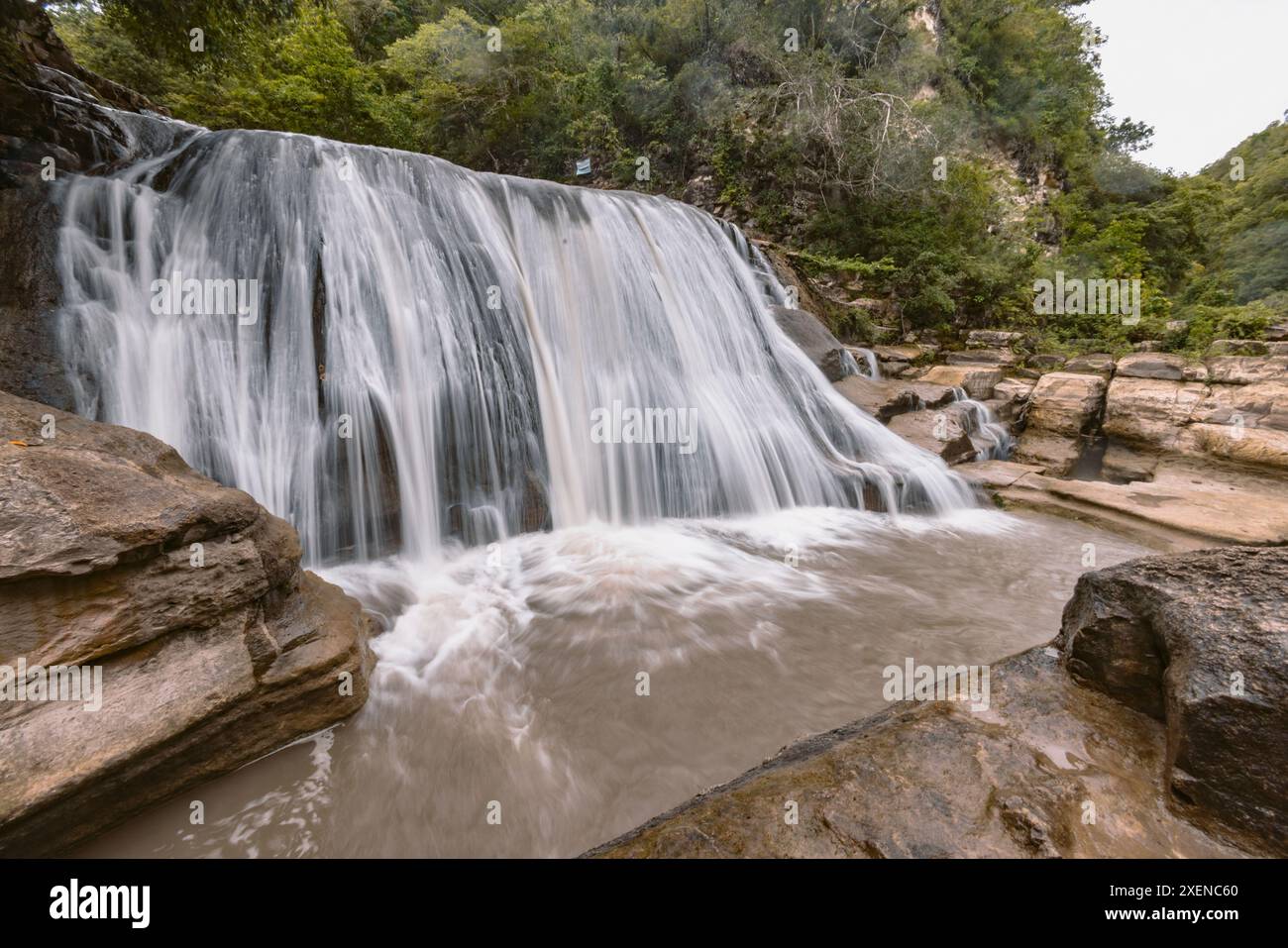 Waterfall splashing on rocky landscape at Air Terjun Tanggedu ...