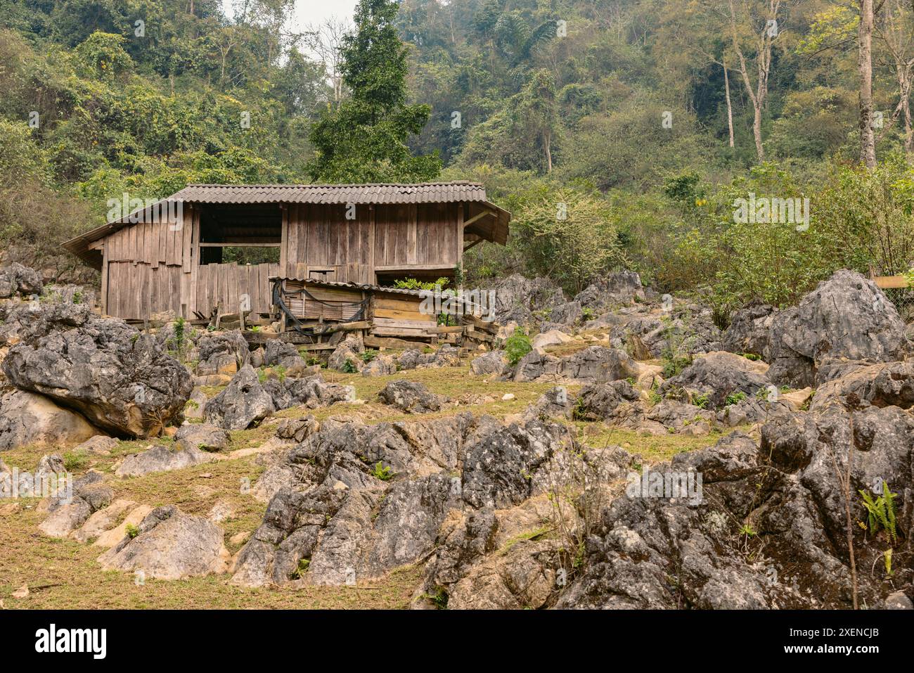Traditional wooden structure built on a rocky terrain in a village in ...