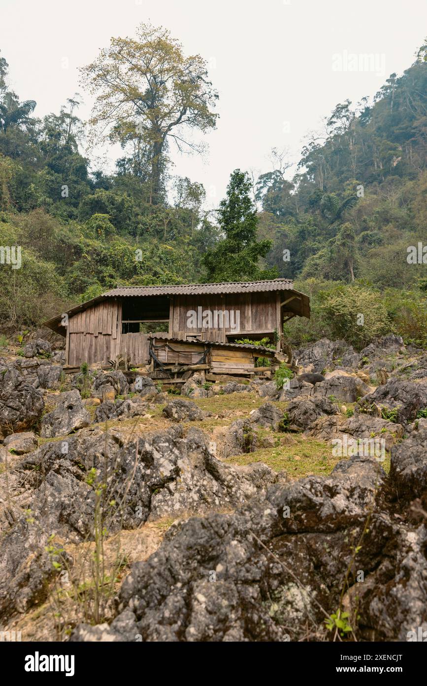 Traditional wooden structure built on a rocky terrain in a village in ...