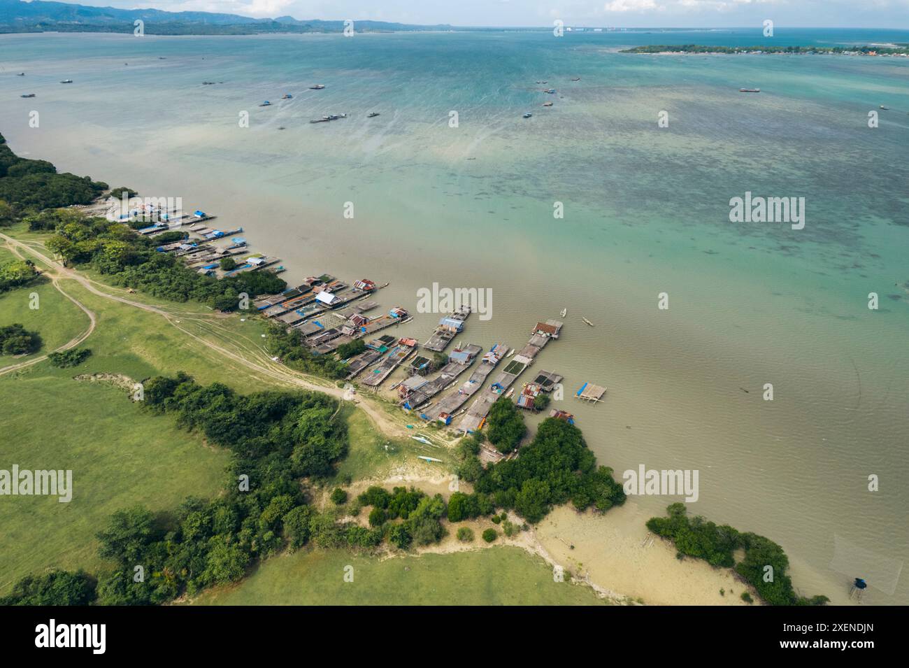 Barges and docks along the shoreline of Mallasoro in South Sulawesi ...