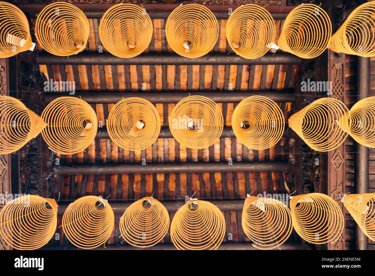 Spiral cones hanging in a row inside a Buddhist temple, Ba Thien Hau ...