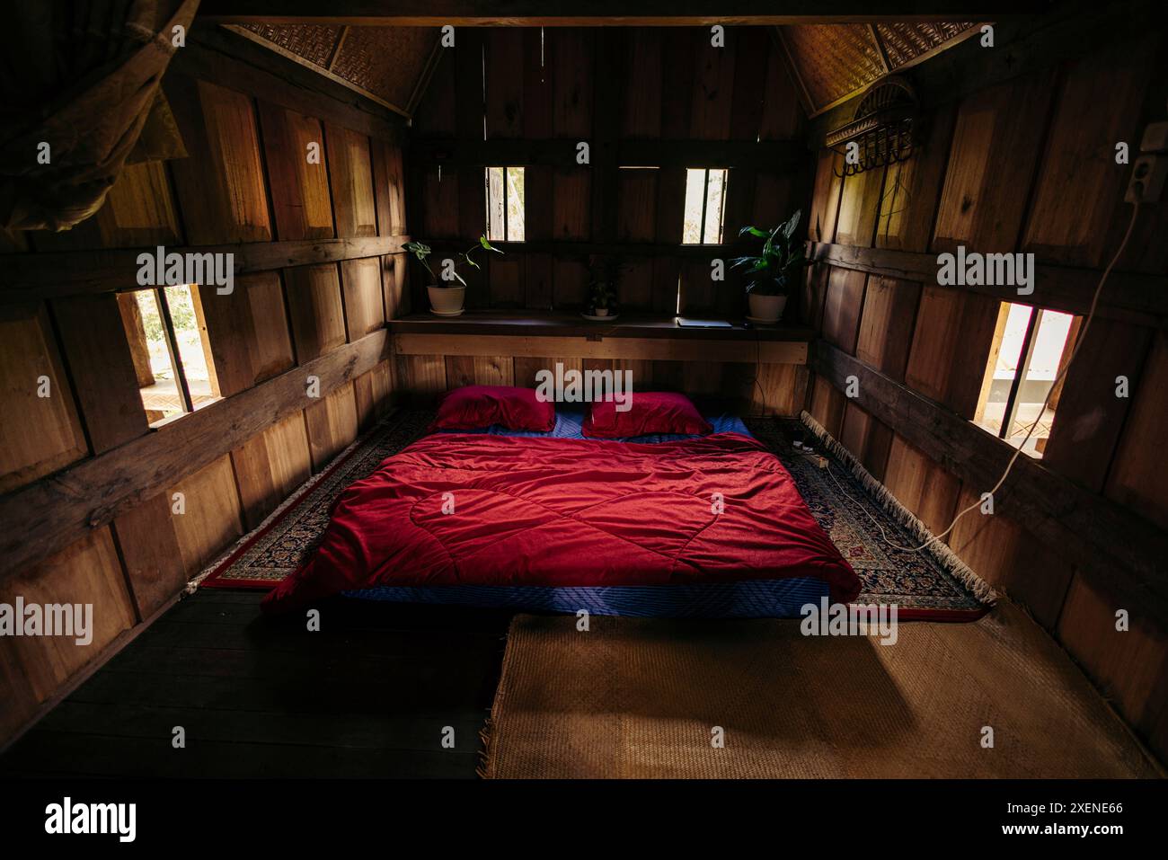 Interior of a traditional home called Tongkonan, with a mattress on the ...