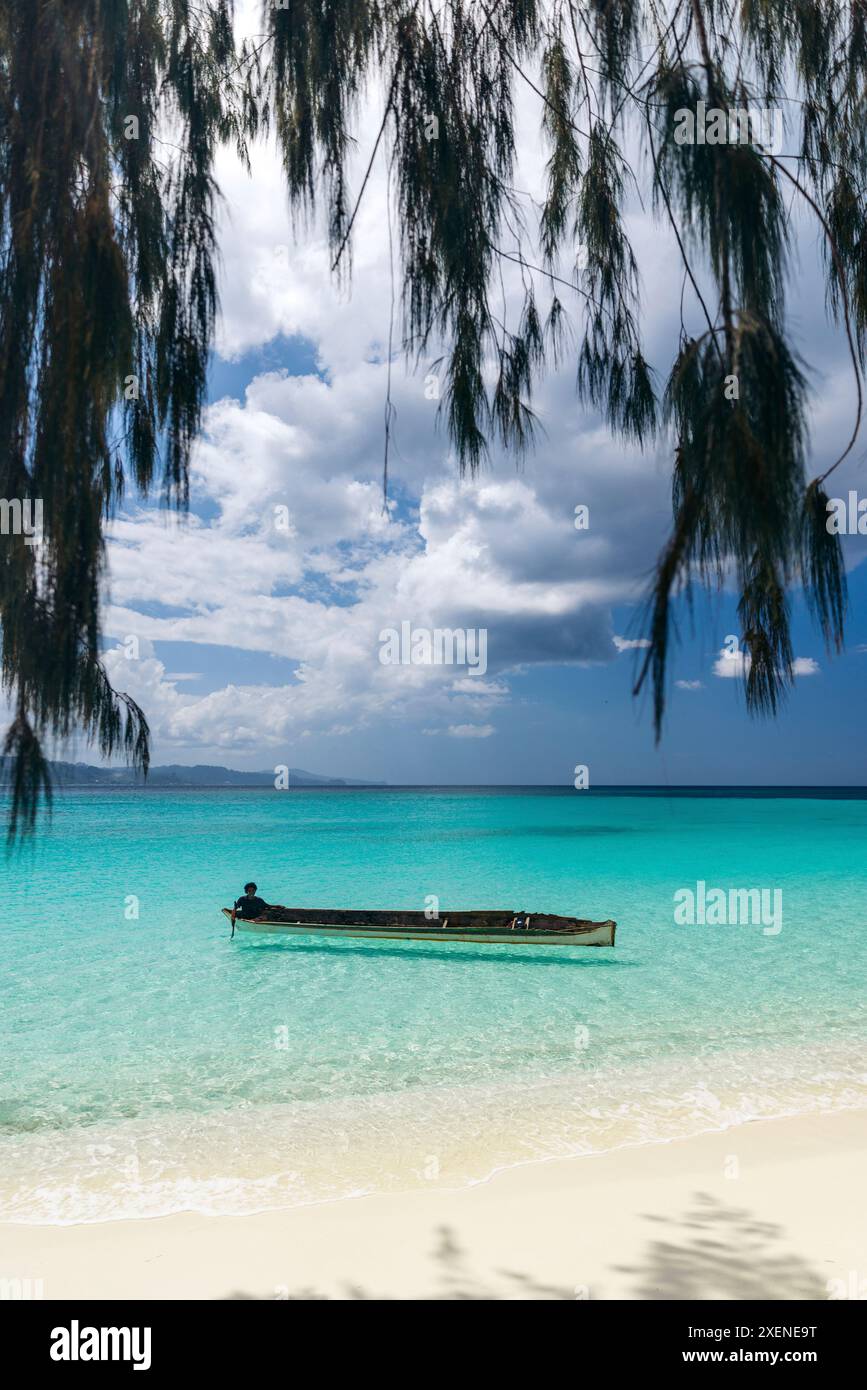 Canoeing in the turquoise water along a white sand beach, Pantai Oyama ...