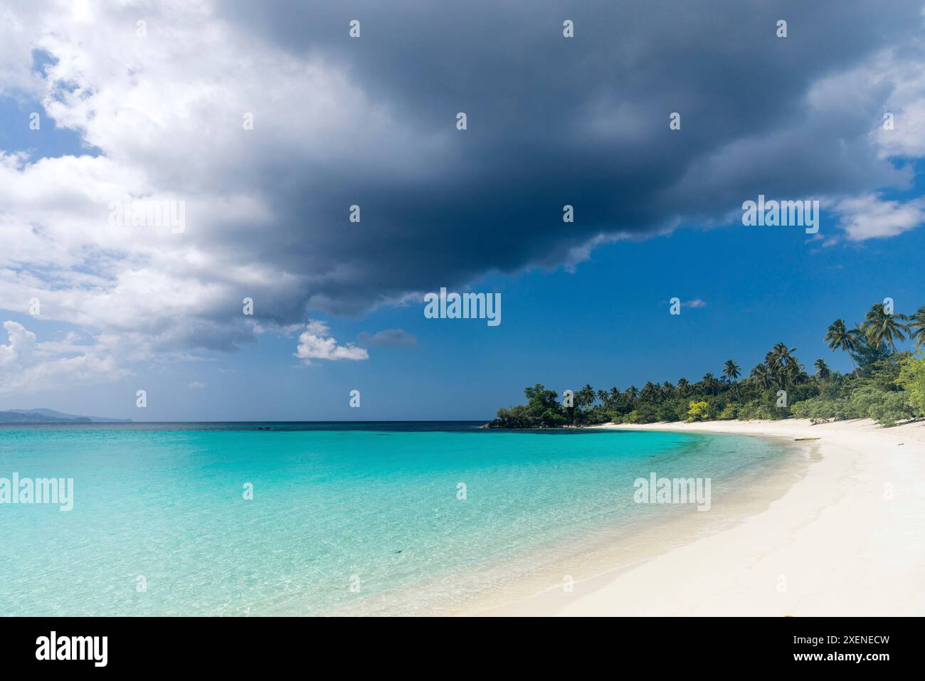 Dramatic cloud formation over the exotic white sand and clear turquoise ...