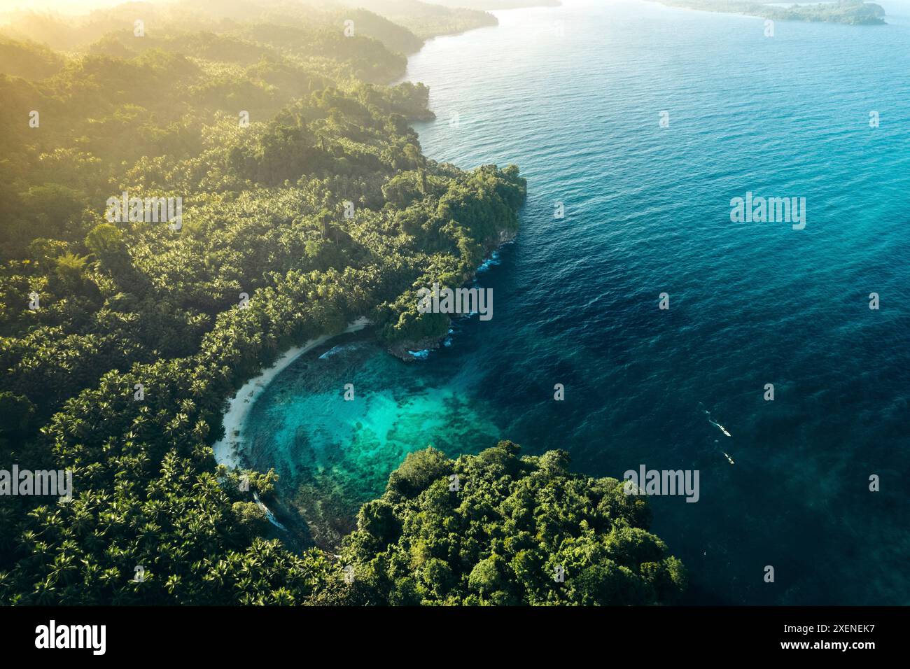 White sand beach along the vast coastline in warm sunlight, at Pantai ...