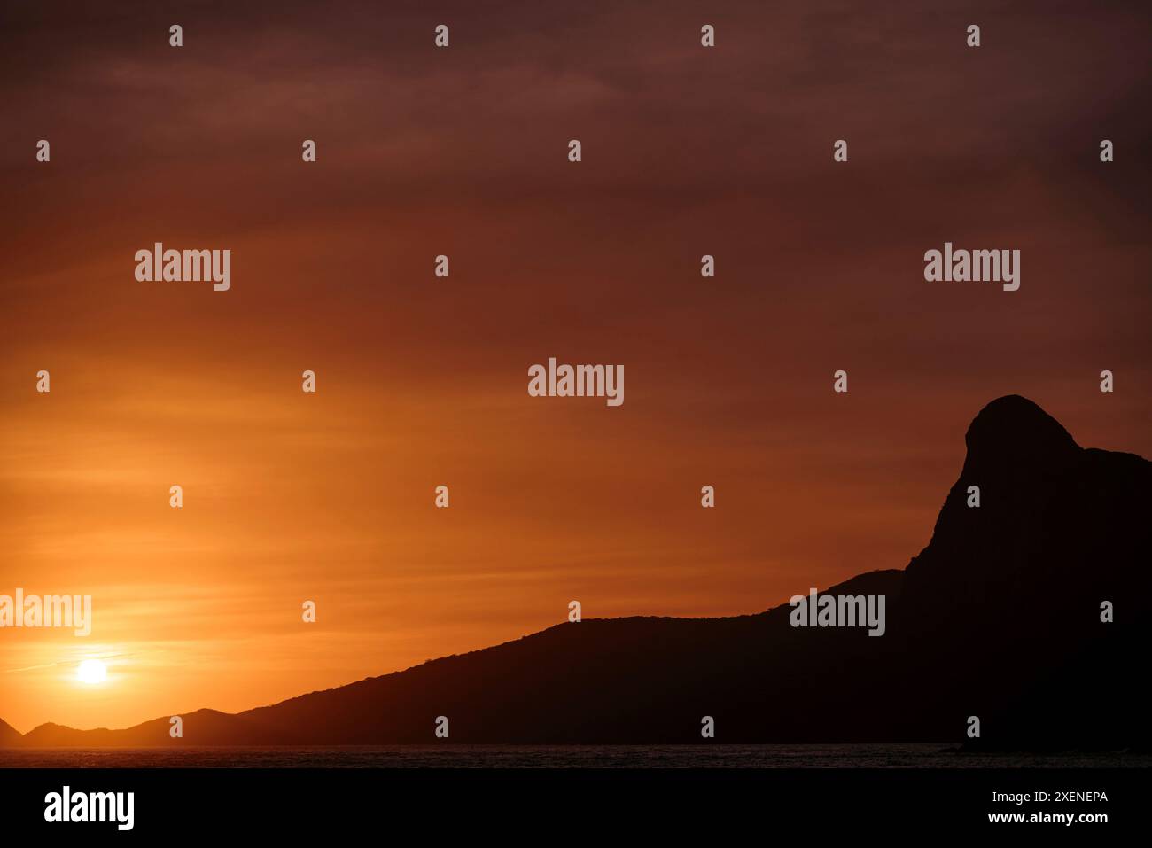 Golden sun glowing in a golden sunset sky; Bai Nhat, Con Dao, Vietnam ...