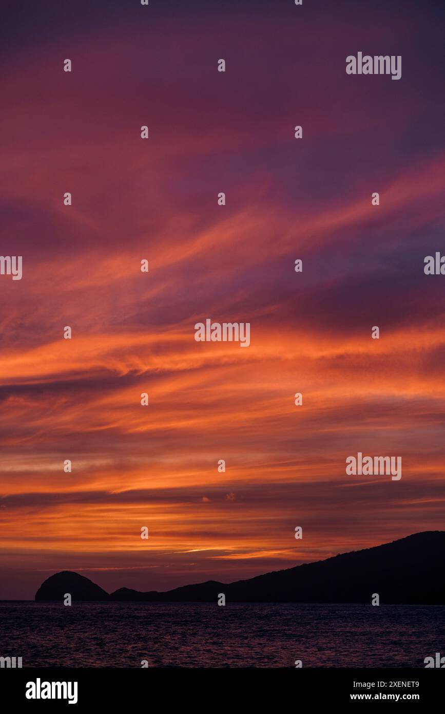 Last light of day under a dramatic glowing sky with a silhouetted ...