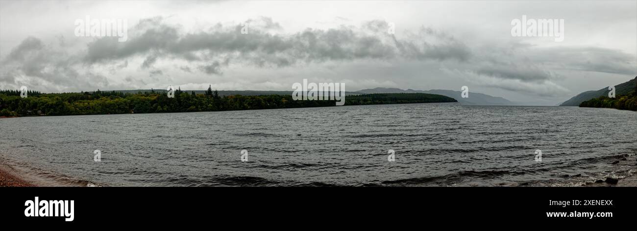 Forest alongside waves on Loch Ness in cloudy weather, panorama ...
