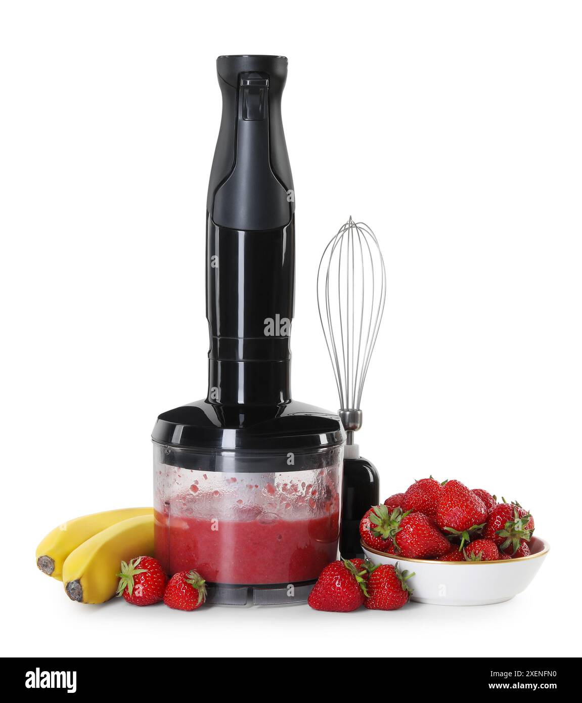 Hand blender with mixture of ingredients, fresh fruits and whisk ...
