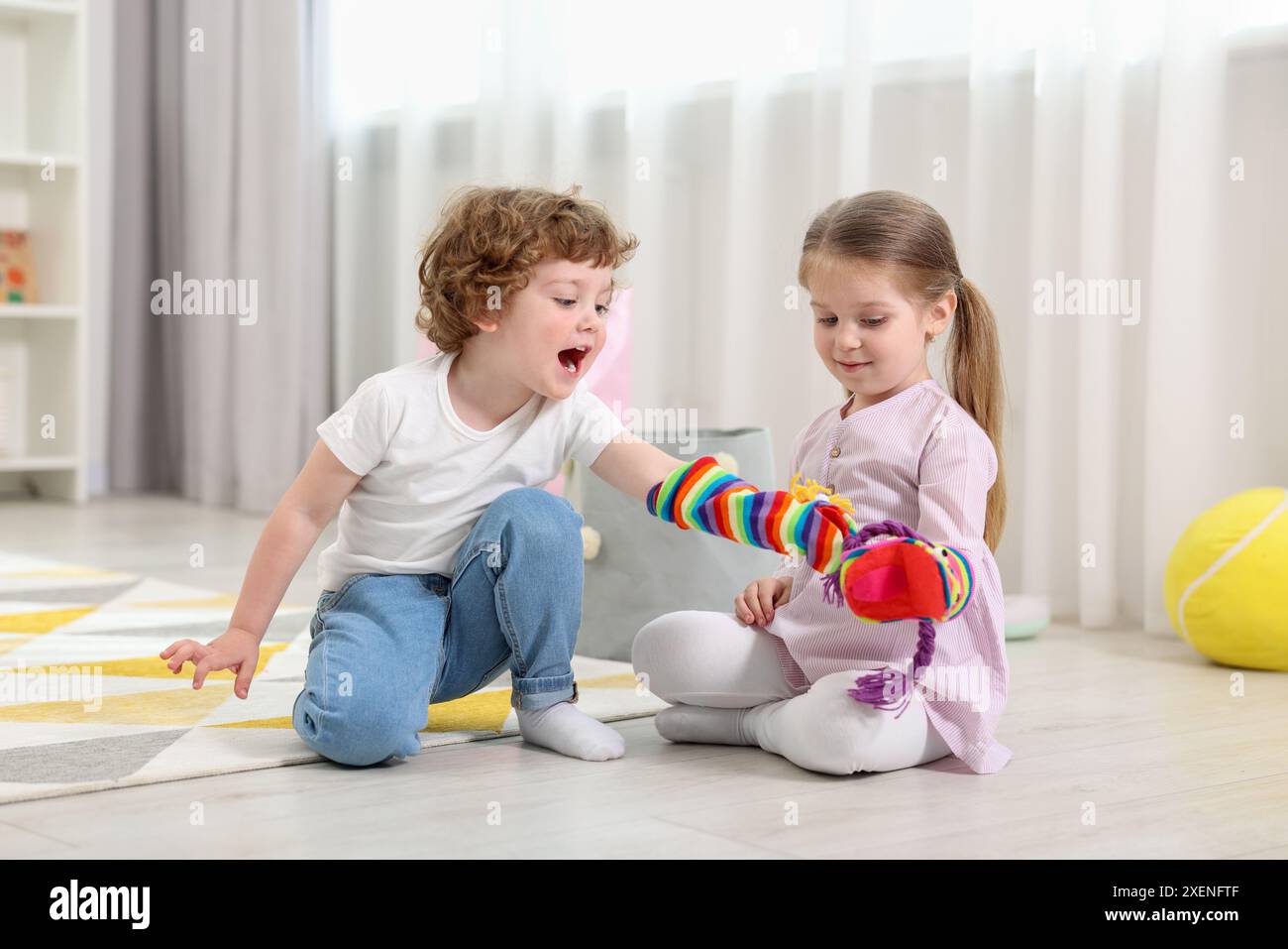 Cute little children playing with funny sock puppets in kindergarten ...