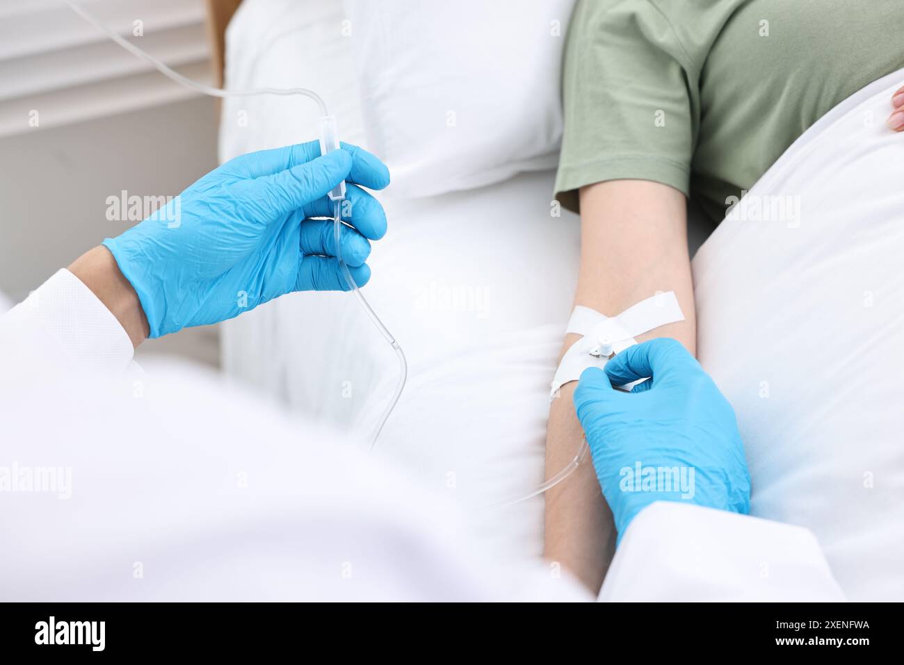 Nurse inserting IV into arm of patient in hospital, closeup Stock Photo ...
