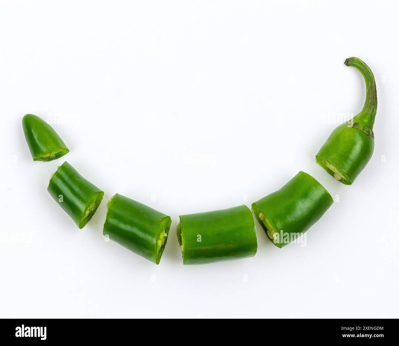 Single green jalapeno chili pepper sliced into sections, overhead shot ...