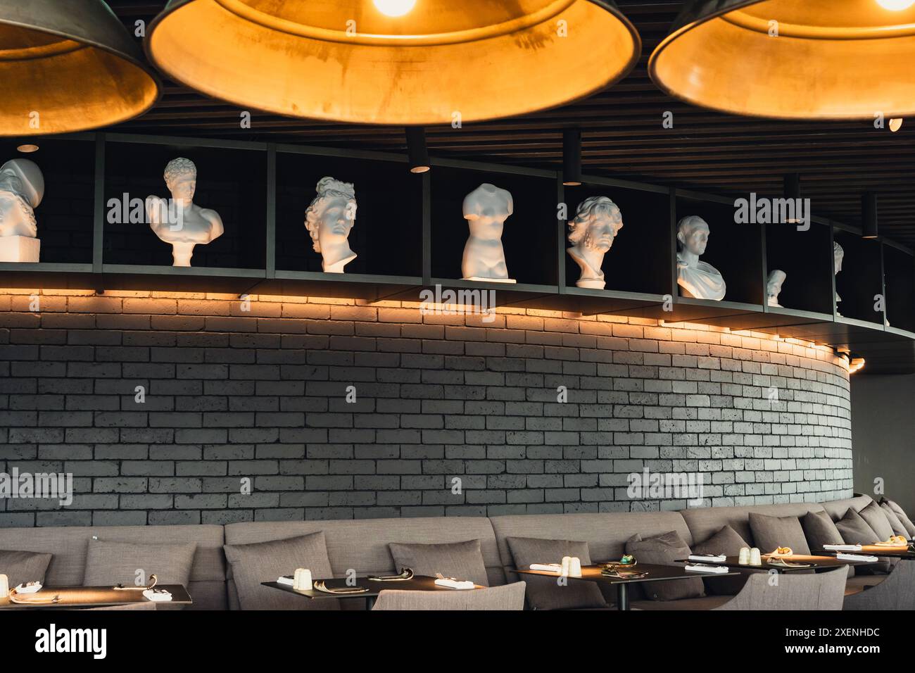 Row of busts is arranged on a shelf in a restaurant interior. The shelf ...