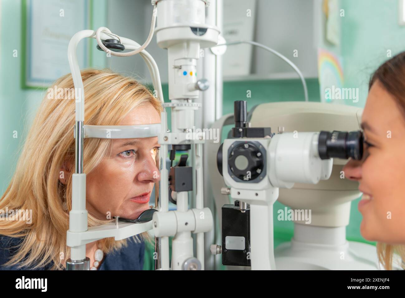 Eye care as an ophthalmologist examines a patient using a slit lamp ...