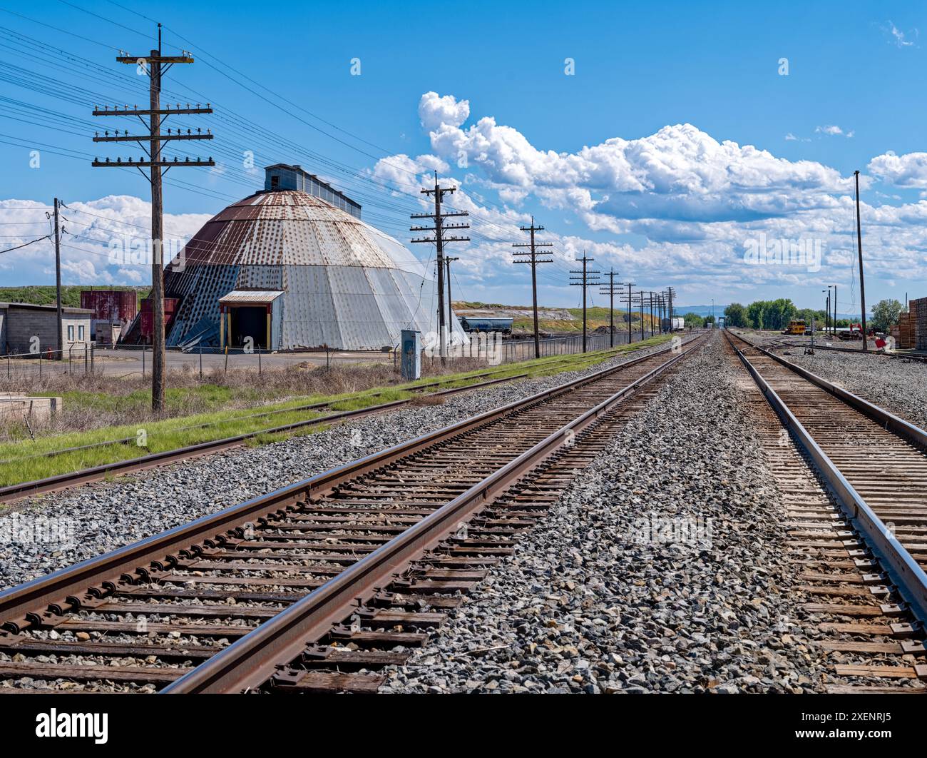 A large metal storage facility by the railroad tracks Stock Photo - Alamy
