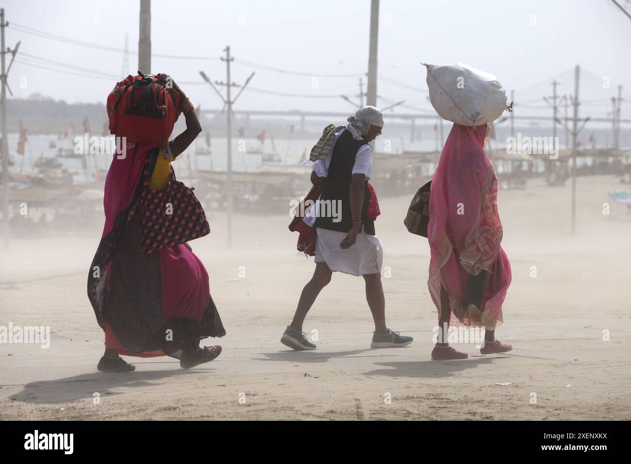 Indian people walk around the banks of river Ganges during the Heat ...