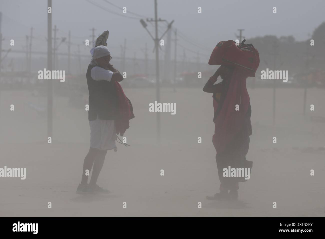 Indian people walk around the banks of river Ganges during the Heat ...