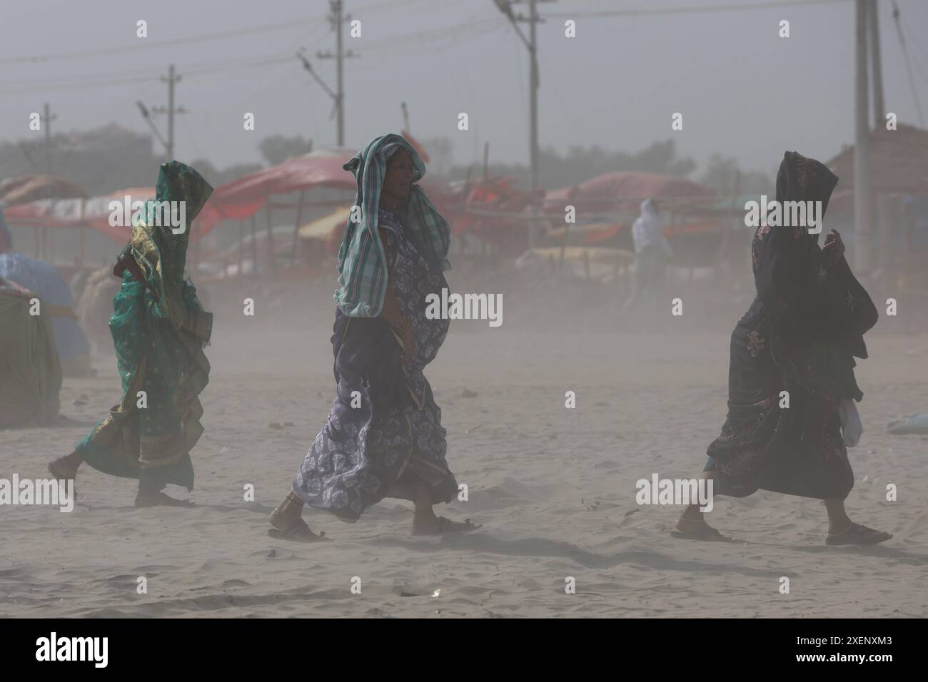 Indian people walk around the banks of river Ganges during the Heat ...