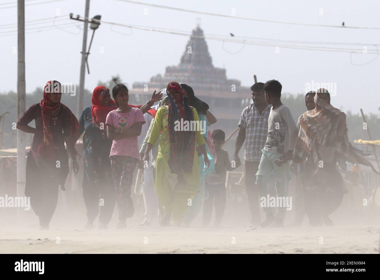 Indian people walk around the banks of river Ganges during the Heat ...