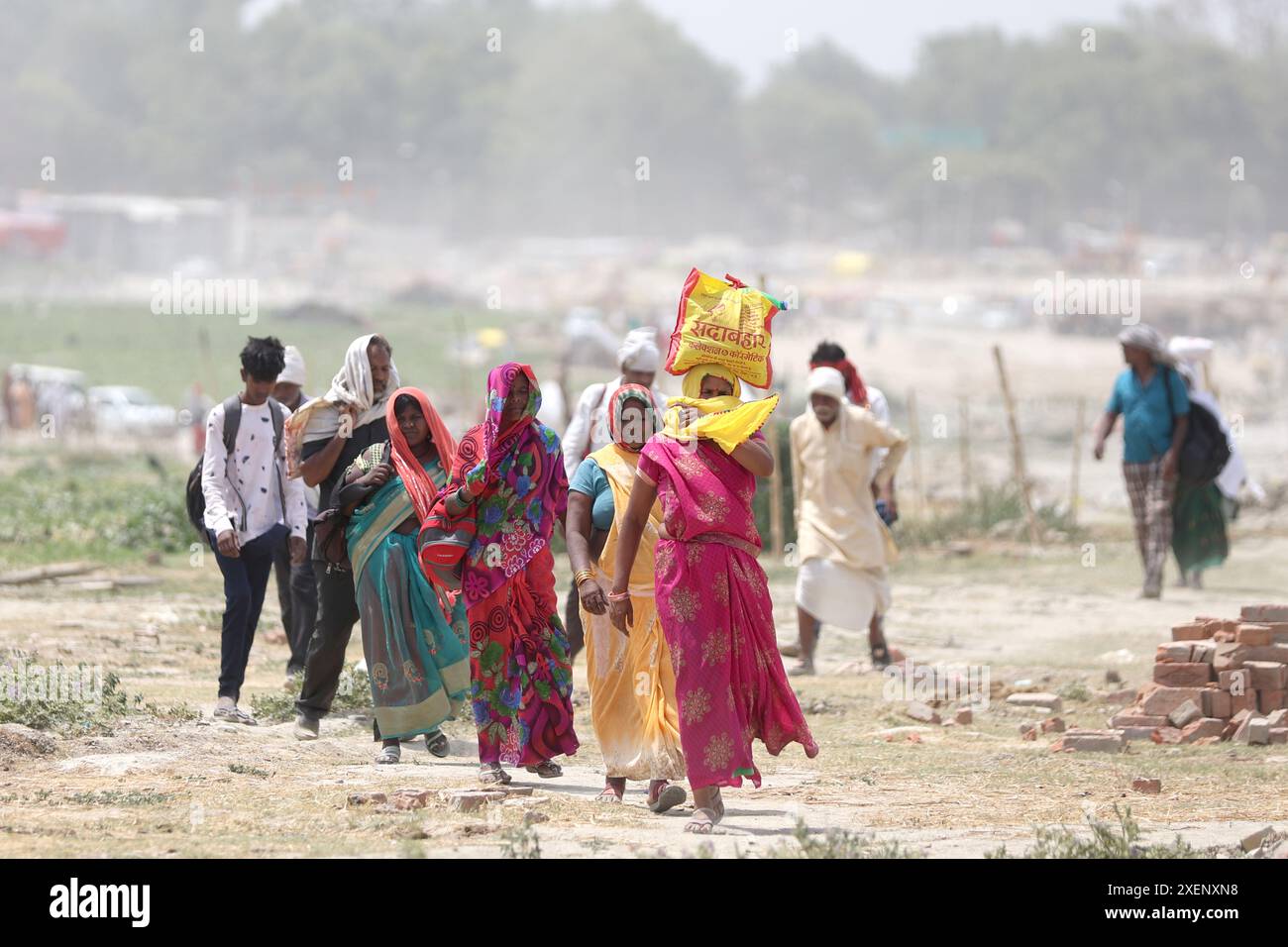 Indian people walk around the banks of river Ganges during the Heat ...