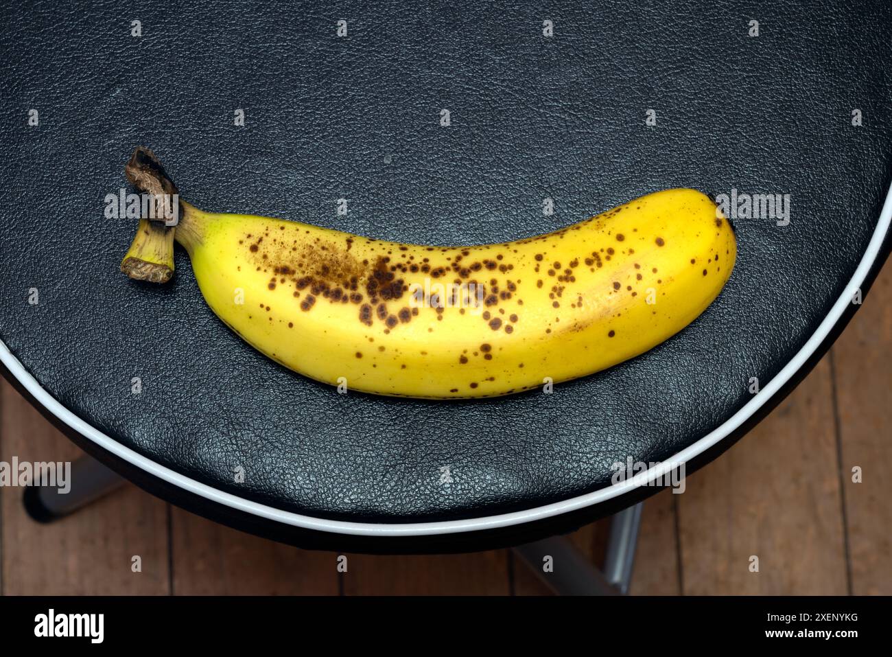 A banana on a foldable stool chair Stock Photo - Alamy