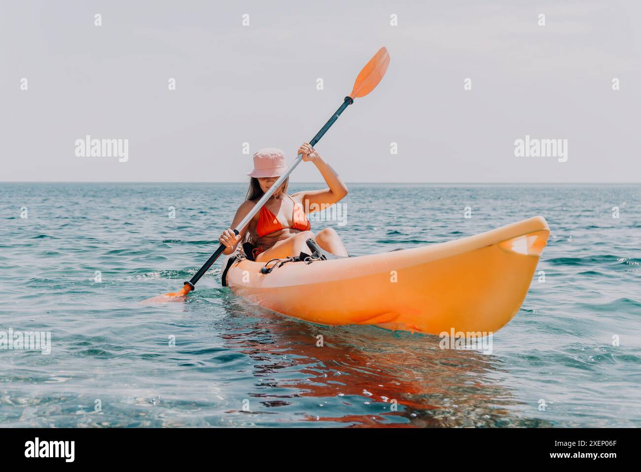 Woman sea kayak. Happy smiling woman paddling in kayak on ocean. Calm ...