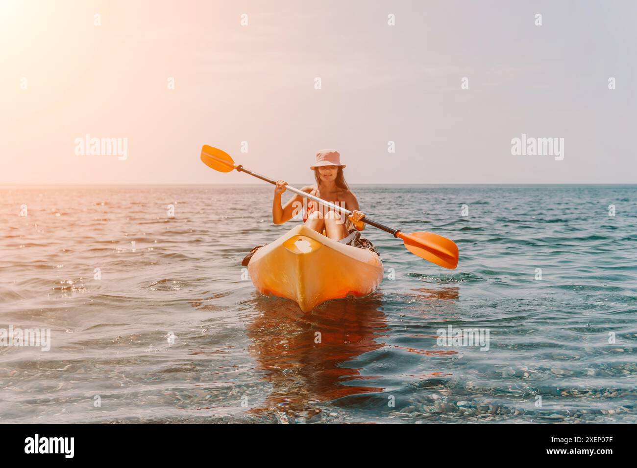 Woman sea kayak. Happy smiling woman paddling in kayak on ocean. Calm ...