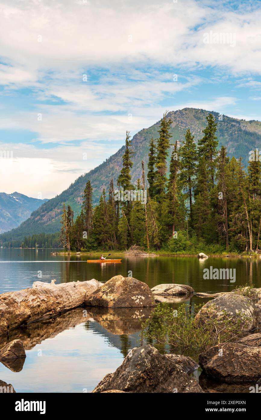A kayaker glides along the water of Lake Wenatchee in Washington State ...